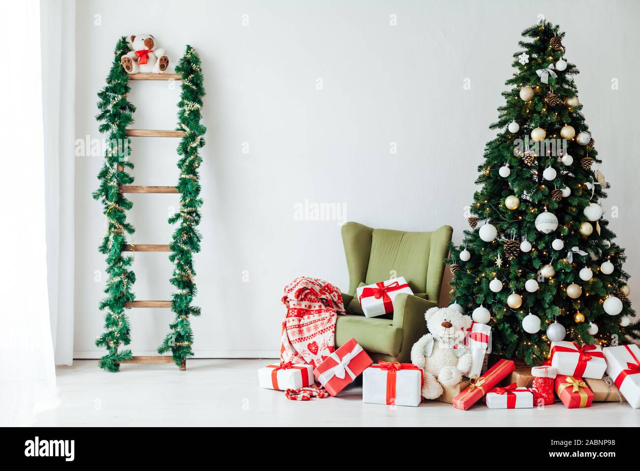 winter Christmas tree with gifts of December decor in the interior of ...