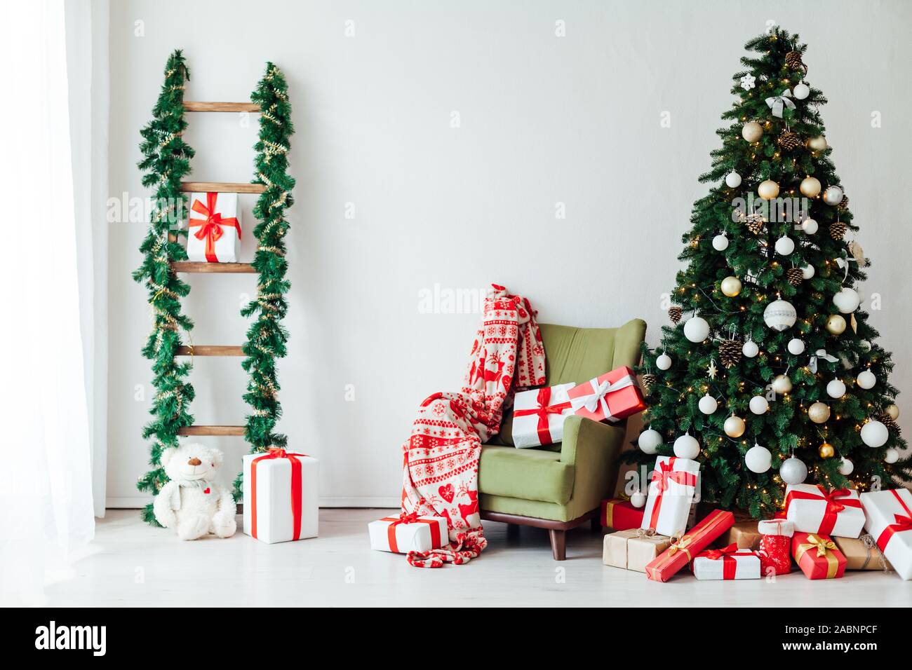 winter Christmas tree with gifts of December decor in the interior of ...