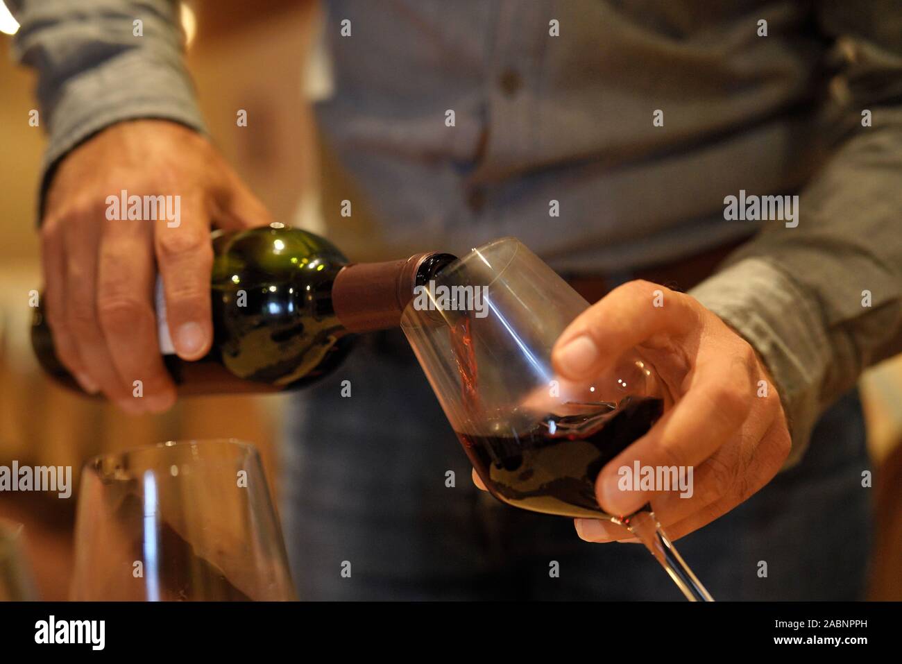 Man serving red wine for tasting in winery Stock Photo - Alamy