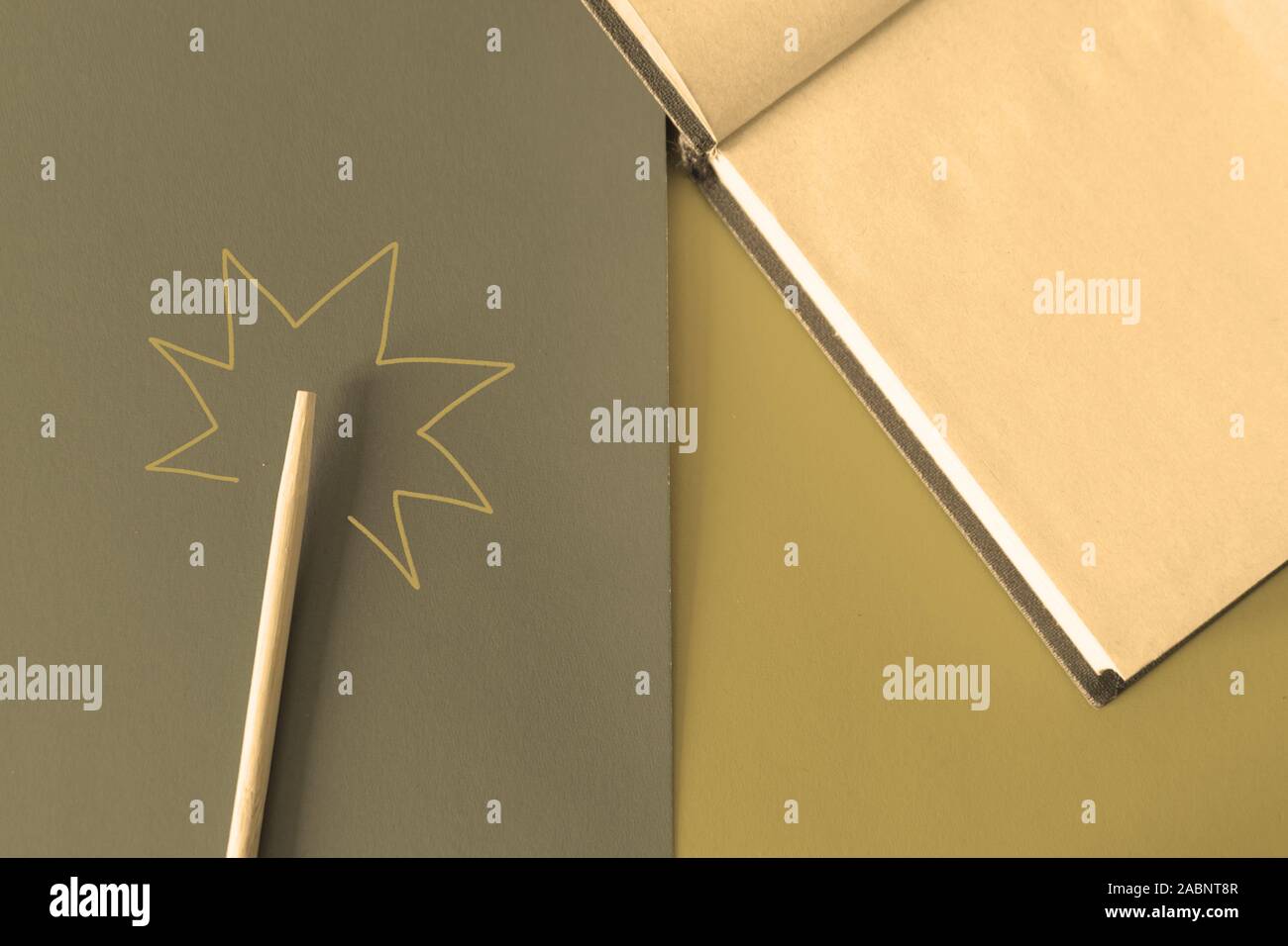 Open book and magical stick. Magical book Stock Photo - Alamy