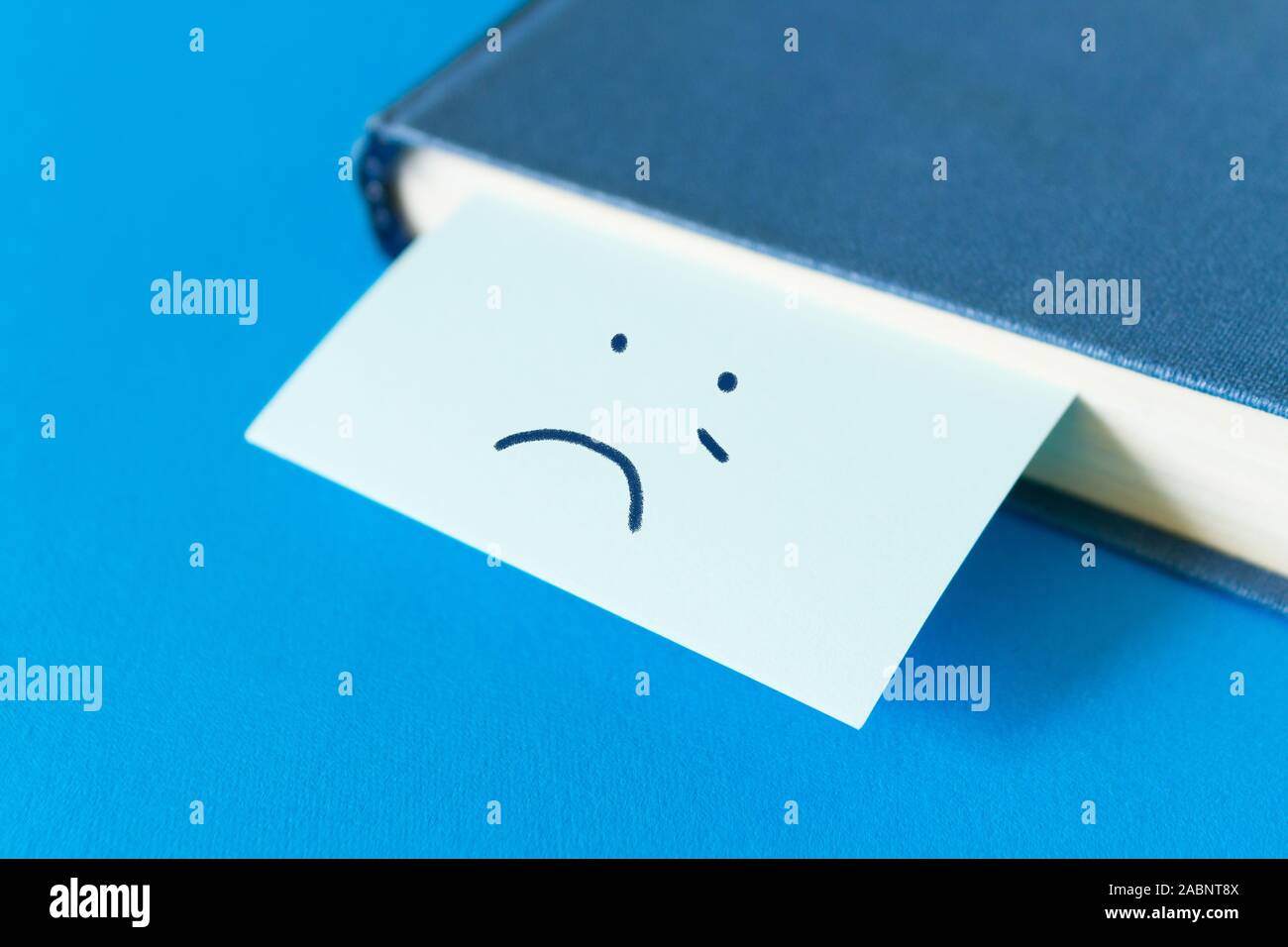 Closed blue book with bookmark in it Stock Photo - Alamy