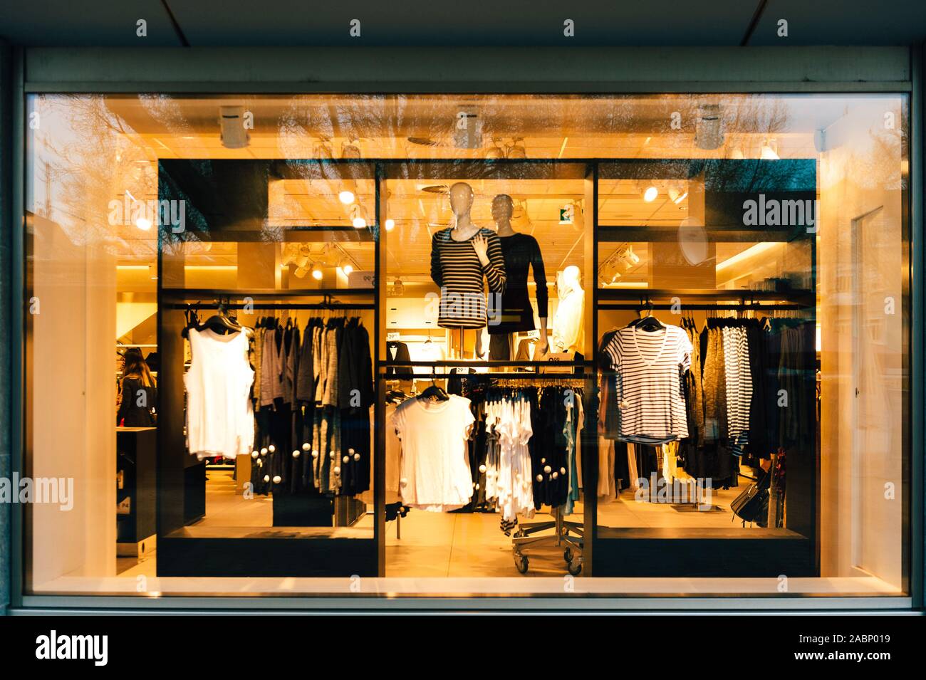 Multiple clothes for sale in the showcase of modern fast-fashion ...