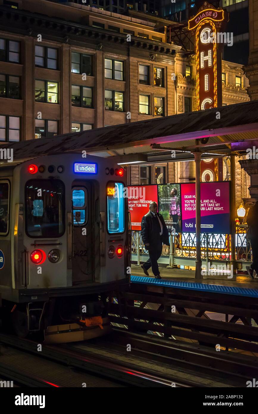 State and Lake L-railway platform with Chicago Theatre looming behind ...