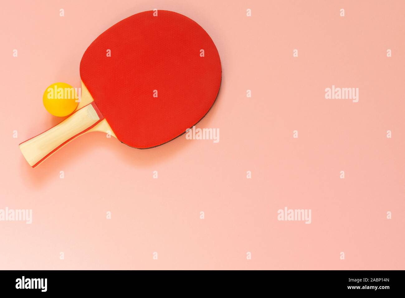 Red tennis ping pong racket isolated on a pink background, sport ...