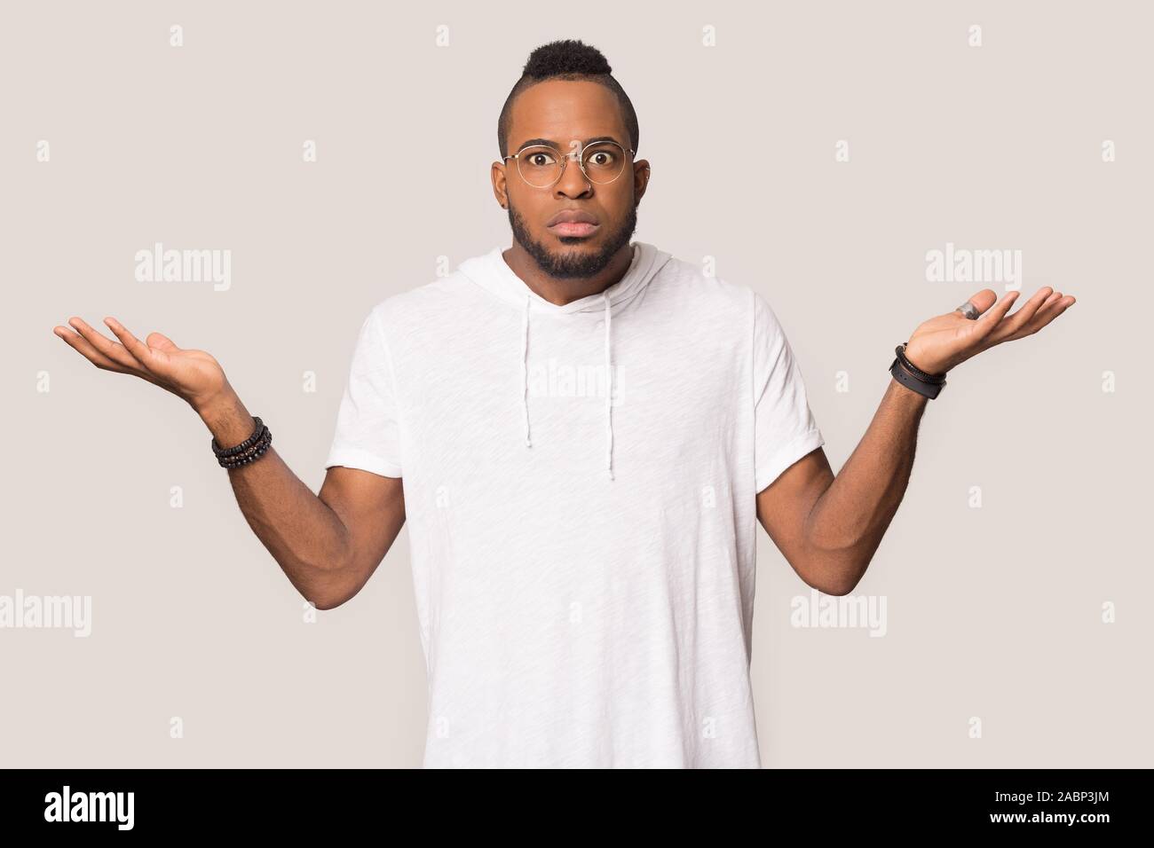 Doubtful African American man shrugging shoulders, feeling confused ...