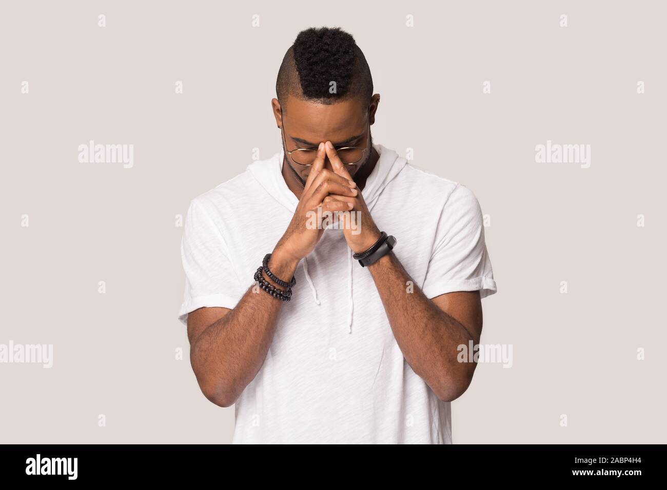 Concentrated young African American man thinking, praying Stock Photo ...