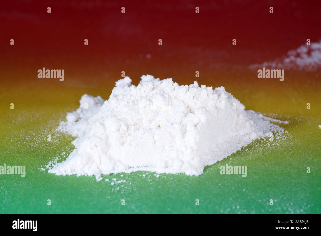 Flour with macro lens photographed against colorful gradient in studio ...