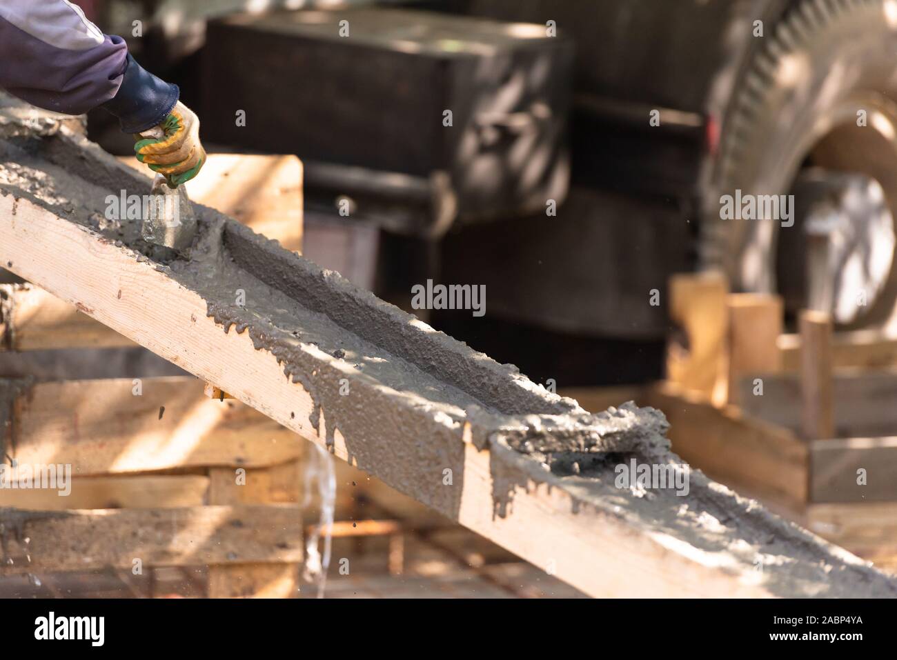 Raking concrete. Concrete for parking lot construction. Thick concrete ...
