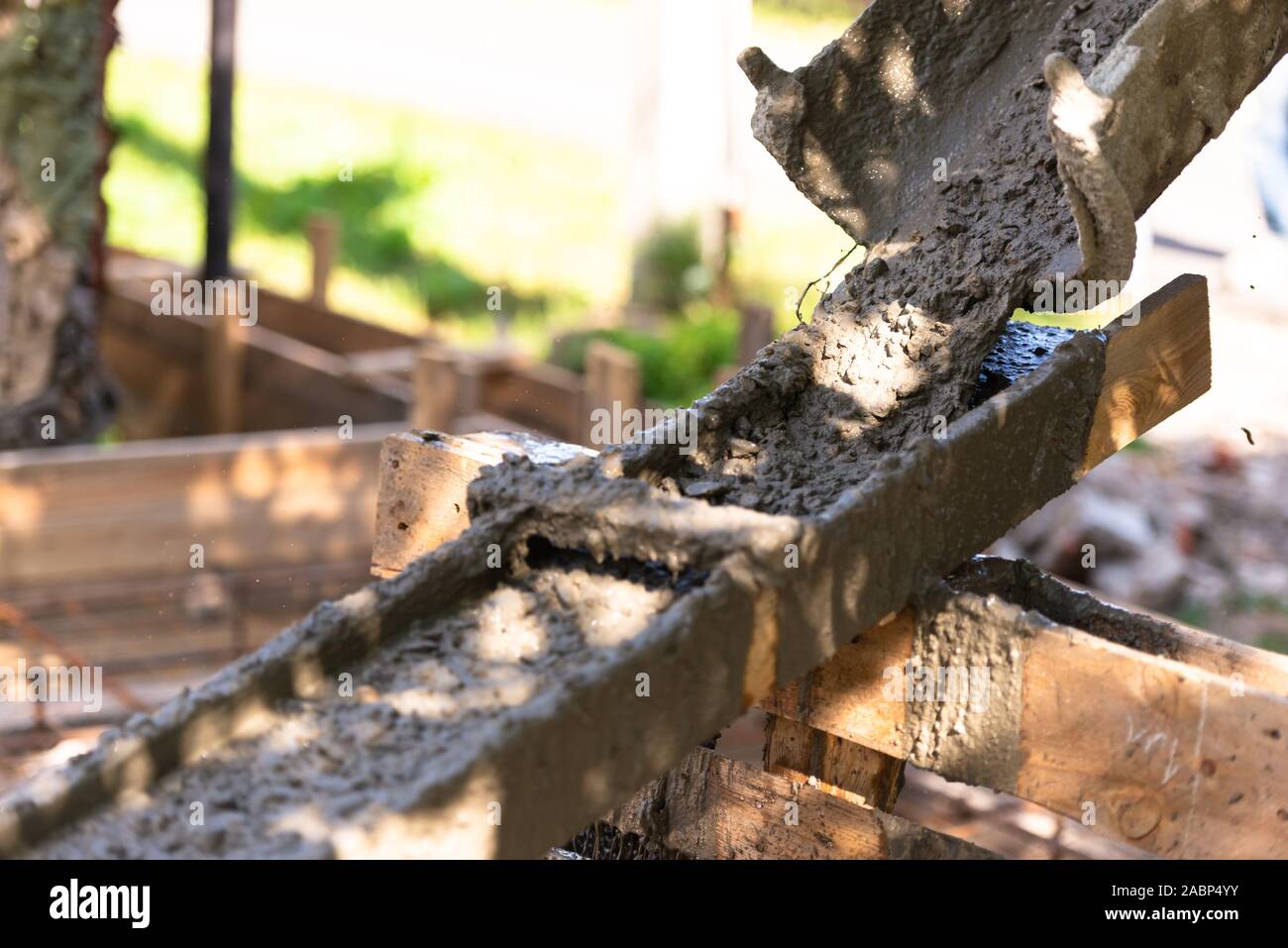 Raking concrete. Concrete for parking lot construction. Thick concrete ...
