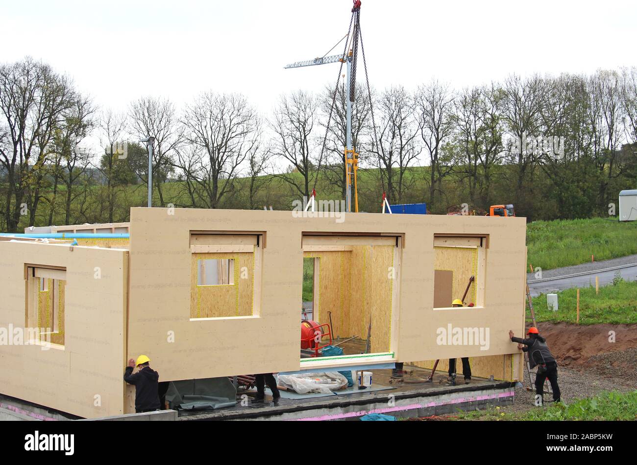 assembly of a prefabricated timber house Stock Photo - Alamy