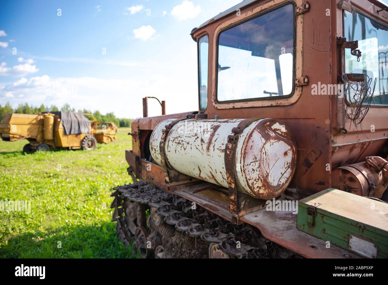 Farm equipment. Old rusty tractor. Preparation for field work. The gas ...