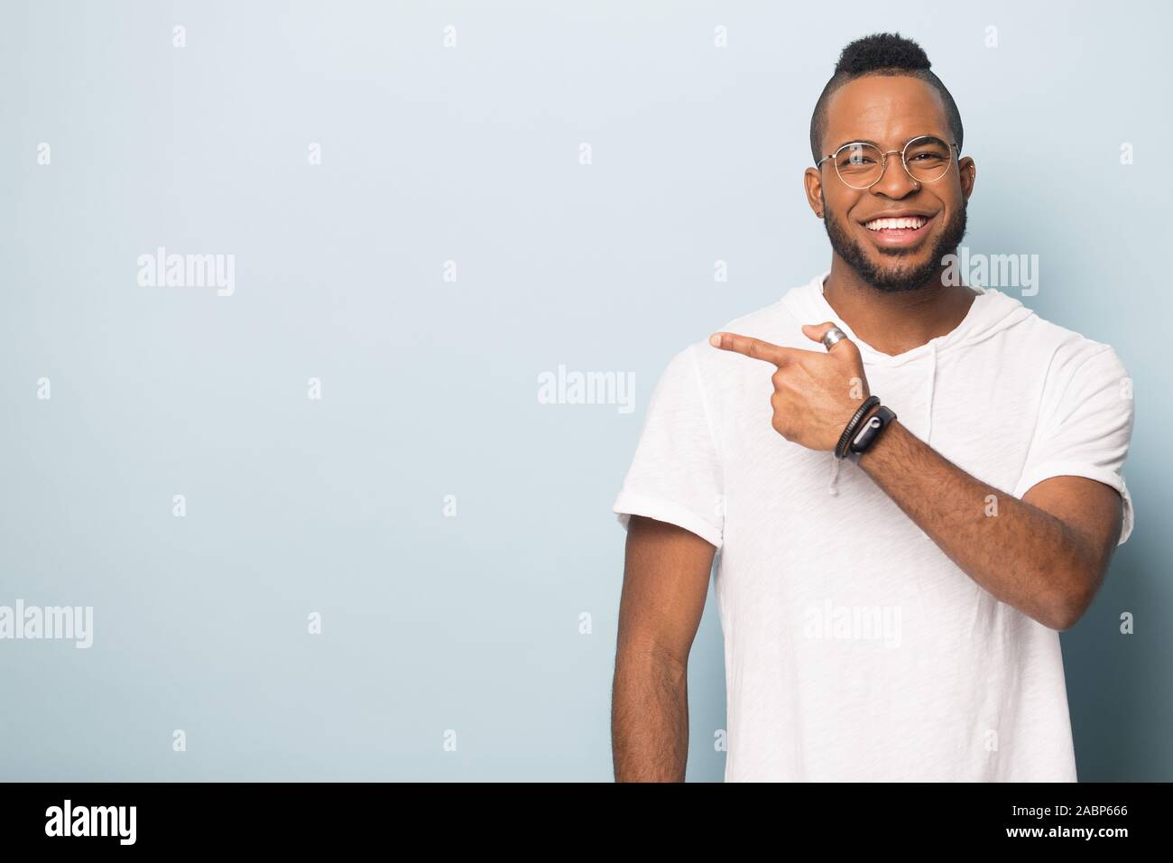 Happy smiling African American man pointing finger on copy space Stock ...