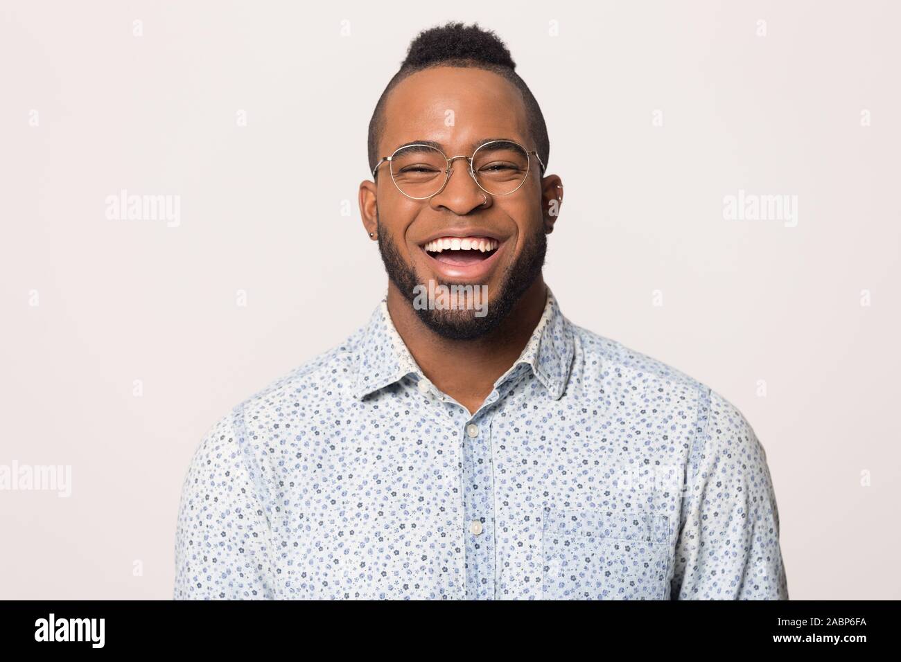 Head shot portrait laughing African American man in glasses isolated ...