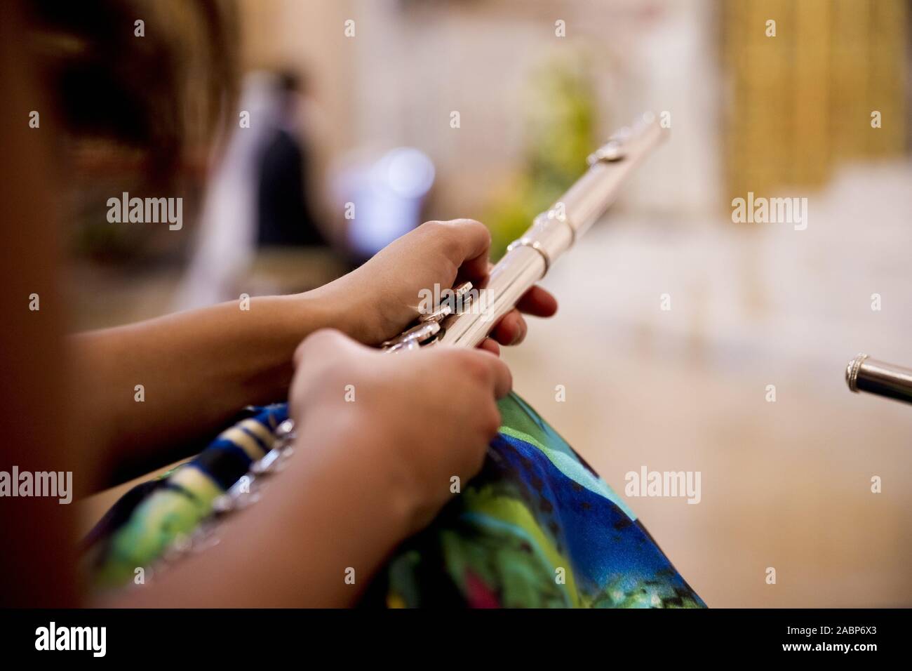 Flute player holding a metal transverse flute in his hands Stock Photo ...