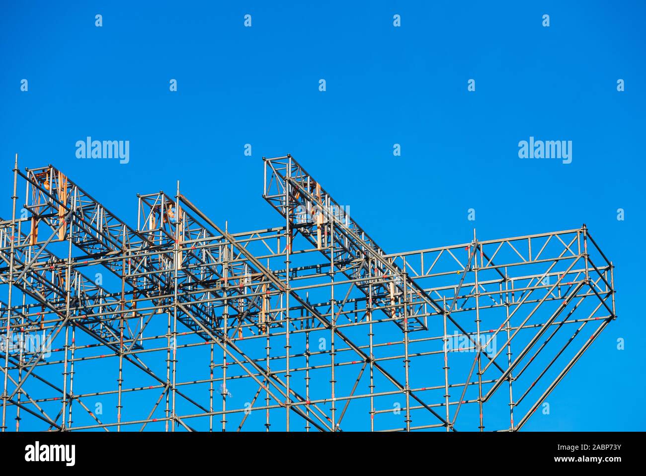 Metallic structure of assembled pipes to hold a stage, blue sky ...