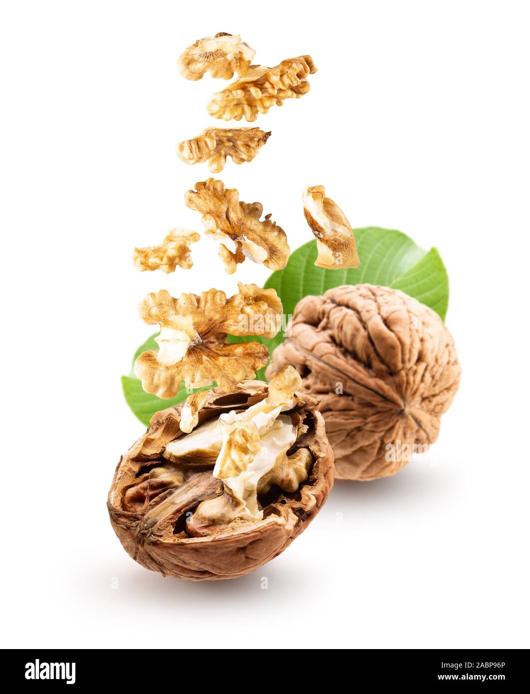 walnuts with falling pieces and leaves isolated on a white background ...