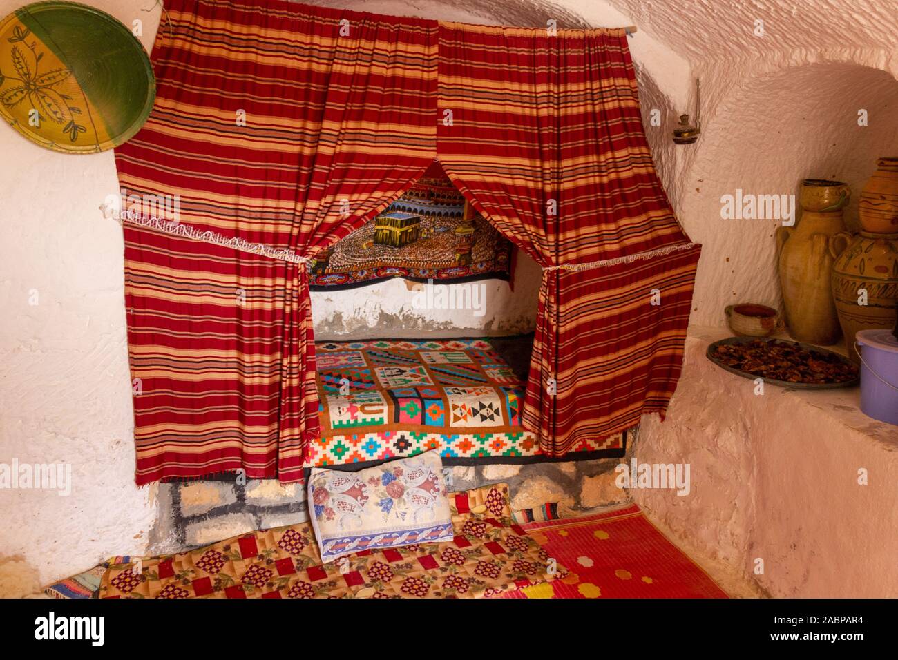 Bed in the bedroom of traditional cave house in the desert of Tunisia ...