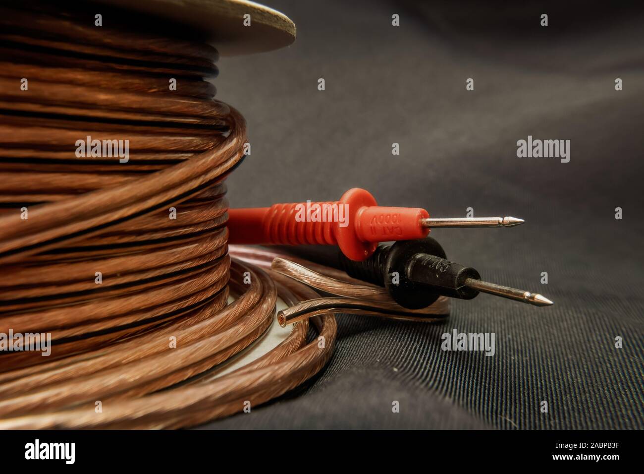 cable roll isolated on dramatic background with volt meter tester Stock ...