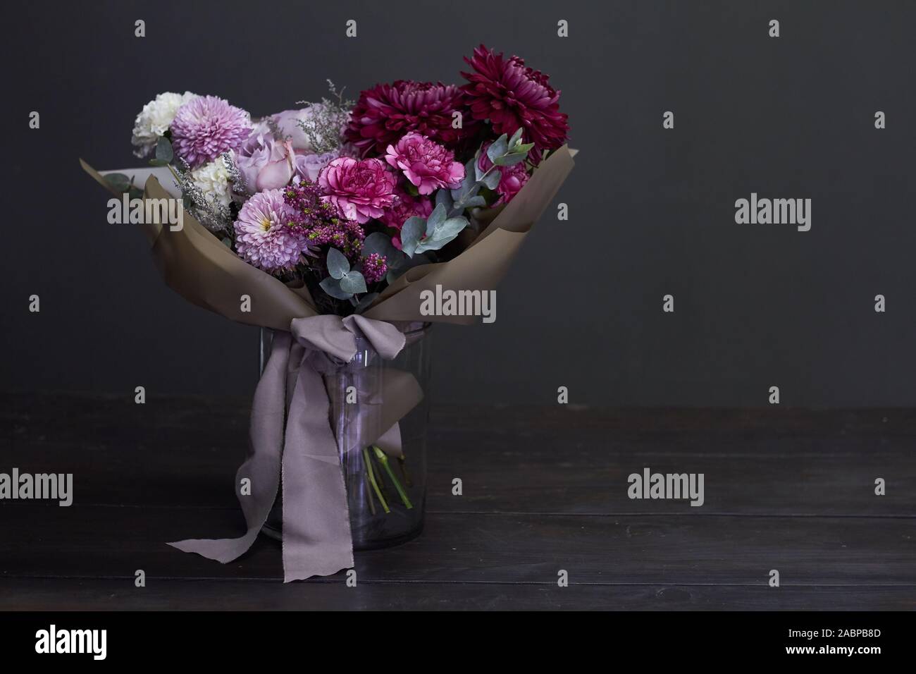 Pink and purple toned bouquet in vintage style on a dark background ...