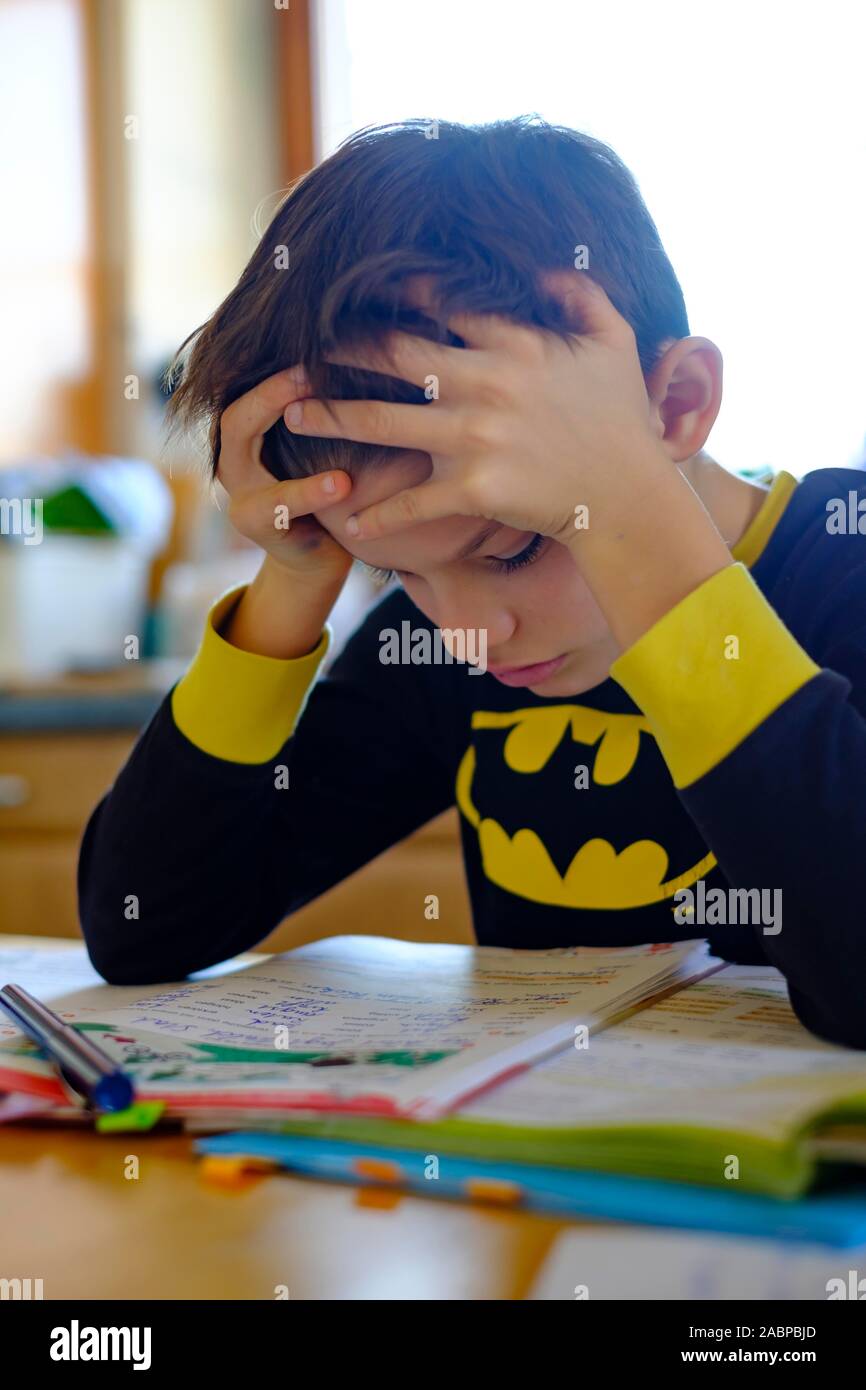Boy, 9 years, brooding over his homework, Germany Stock Photo - Alamy