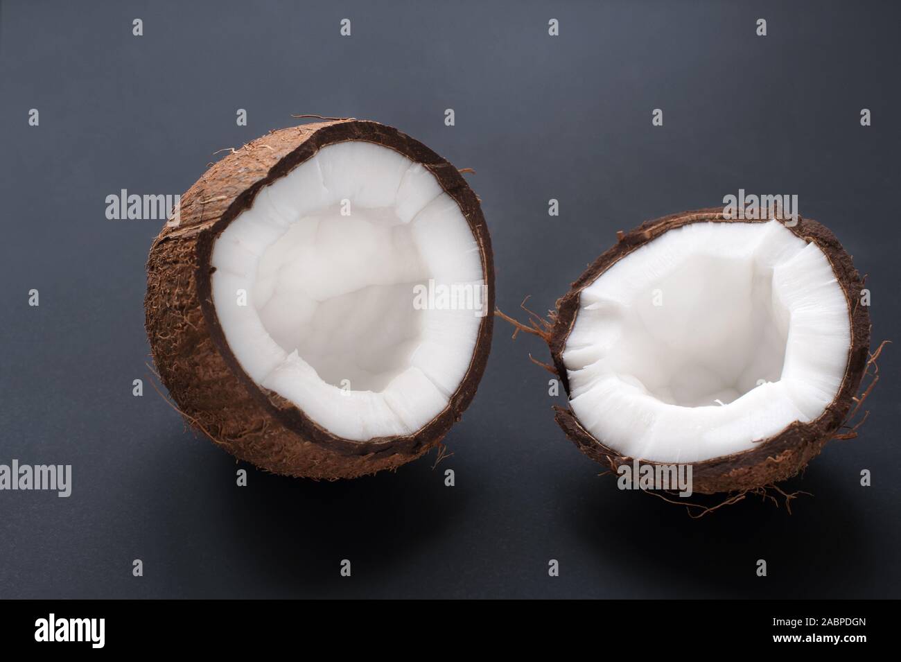 Coconut cut in half on gray background.Tropical fruit abstract ...