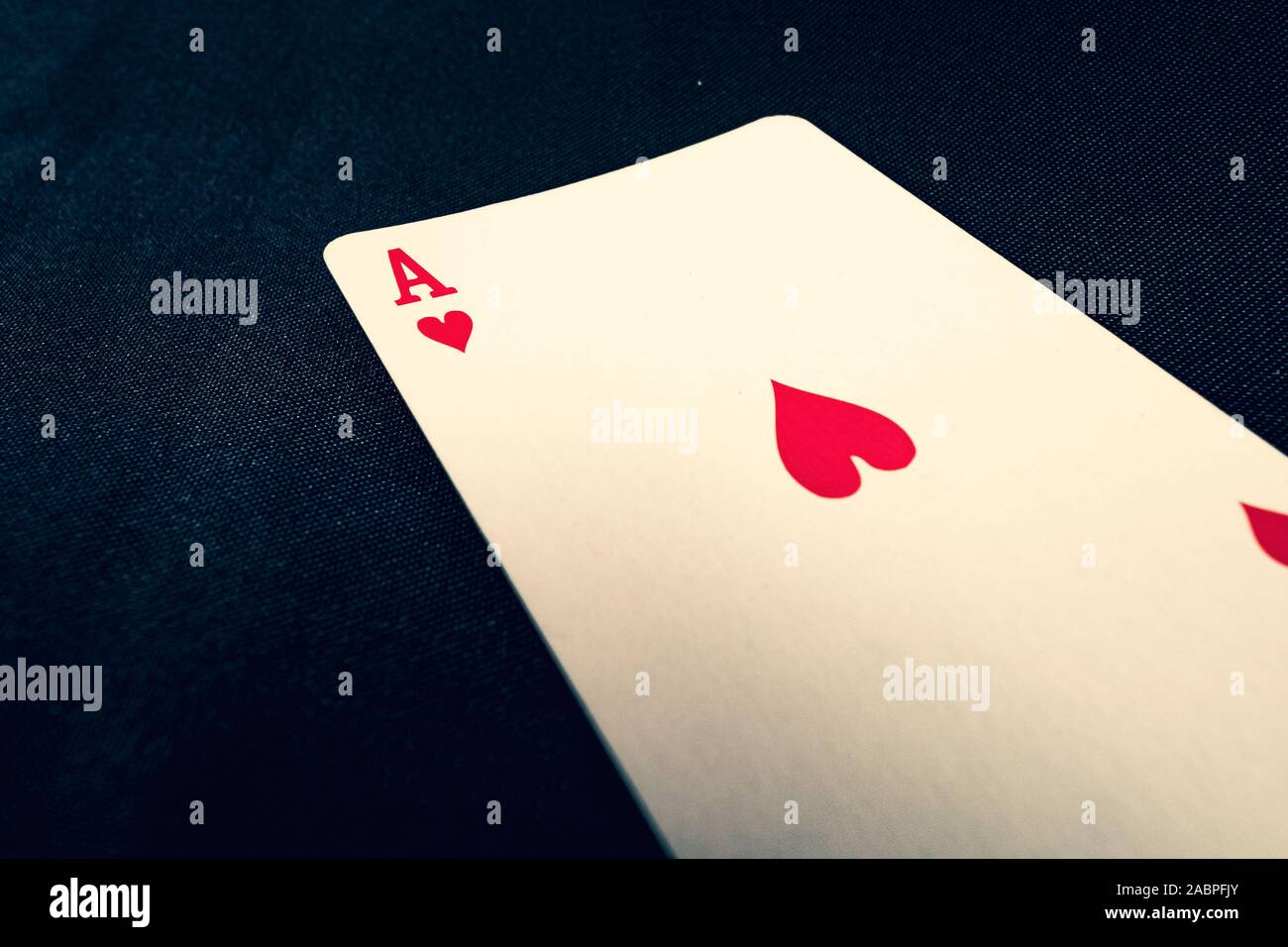 red ace of hearts on black background Stock Photo - Alamy