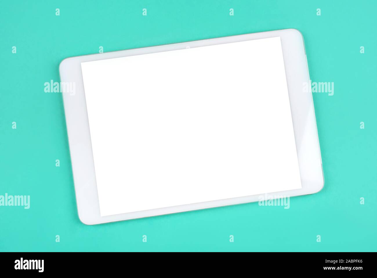 White digital tablet on mint background Stock Photo - Alamy