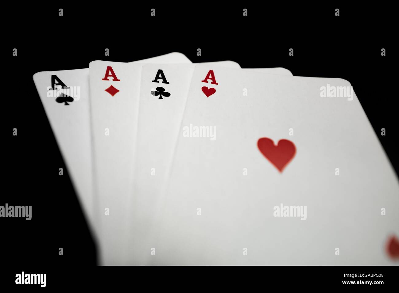four aces playing cards on black background Stock Photo - Alamy