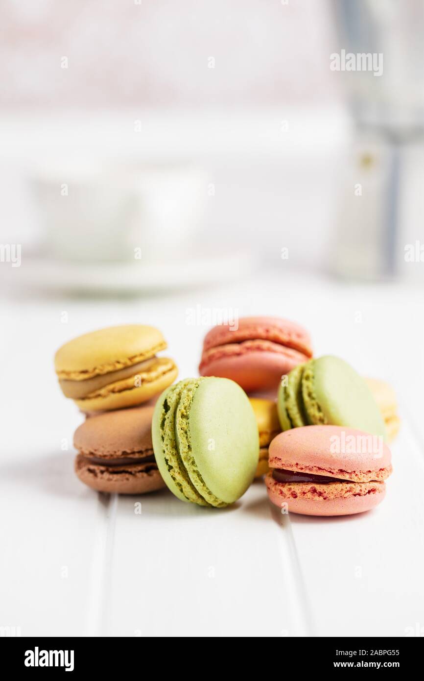 Sweet colorful macarons on white table Stock Photo - Alamy