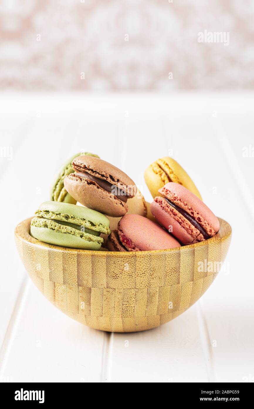 Sweet colorful macarons in wooden bowl Stock Photo - Alamy