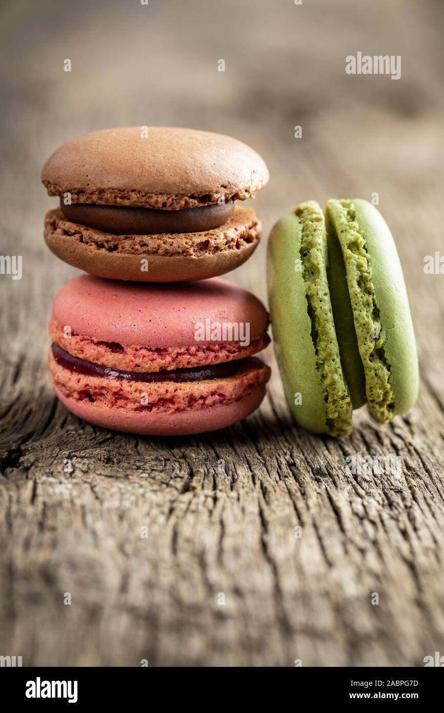 Sweet colorful macarons on old wooden table Stock Photo - Alamy