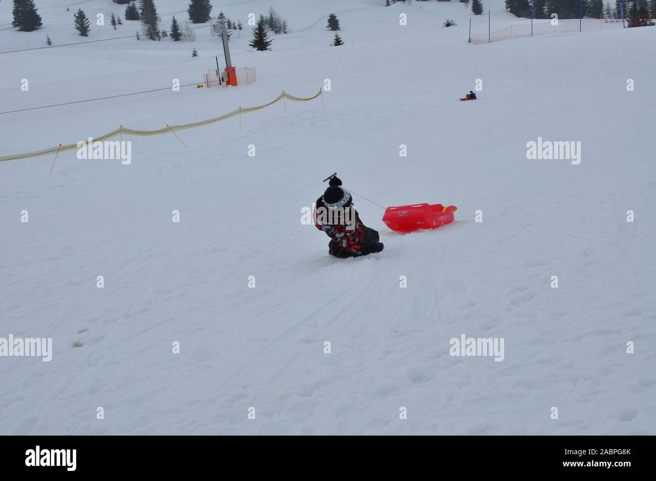 Little boy sledding at the Station des Saisies Savoie France Stock ...
