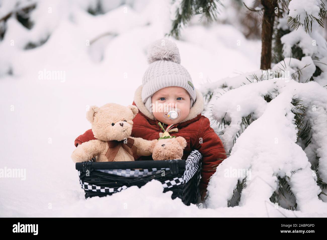 cute little baby boy with teddy bears in winter forest Stock Photo - Alamy