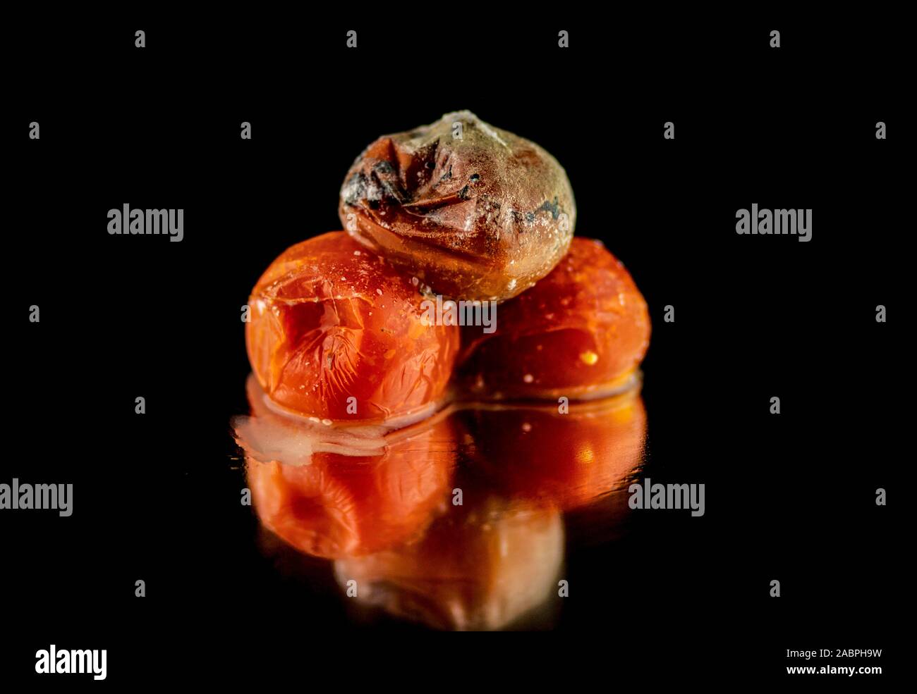 Rotten Fruit with slight decay on a reflective surface Stock Photo - Alamy