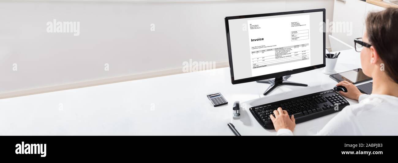 Close-up Of A Businesswoman Using The Computer With Invoice Form On ...