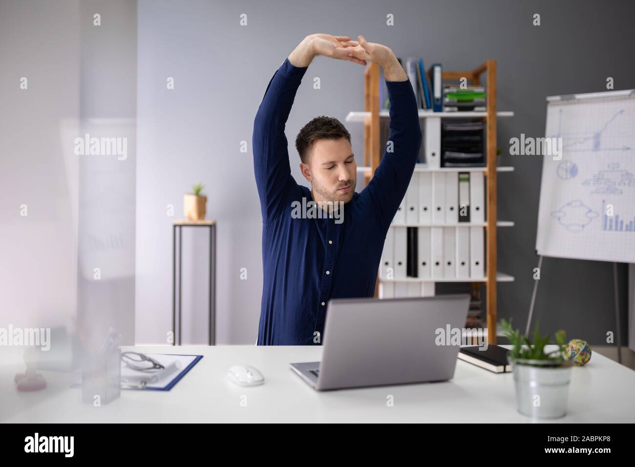 Man stretching in office hi-res stock photography and images - Alamy