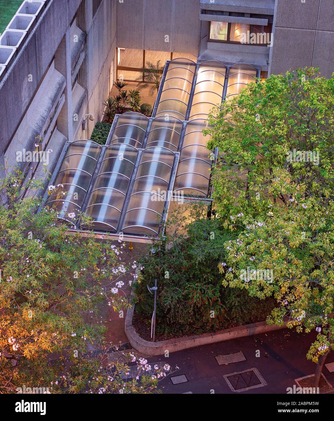 Curved transparent roof at entrance to office building in the city ...