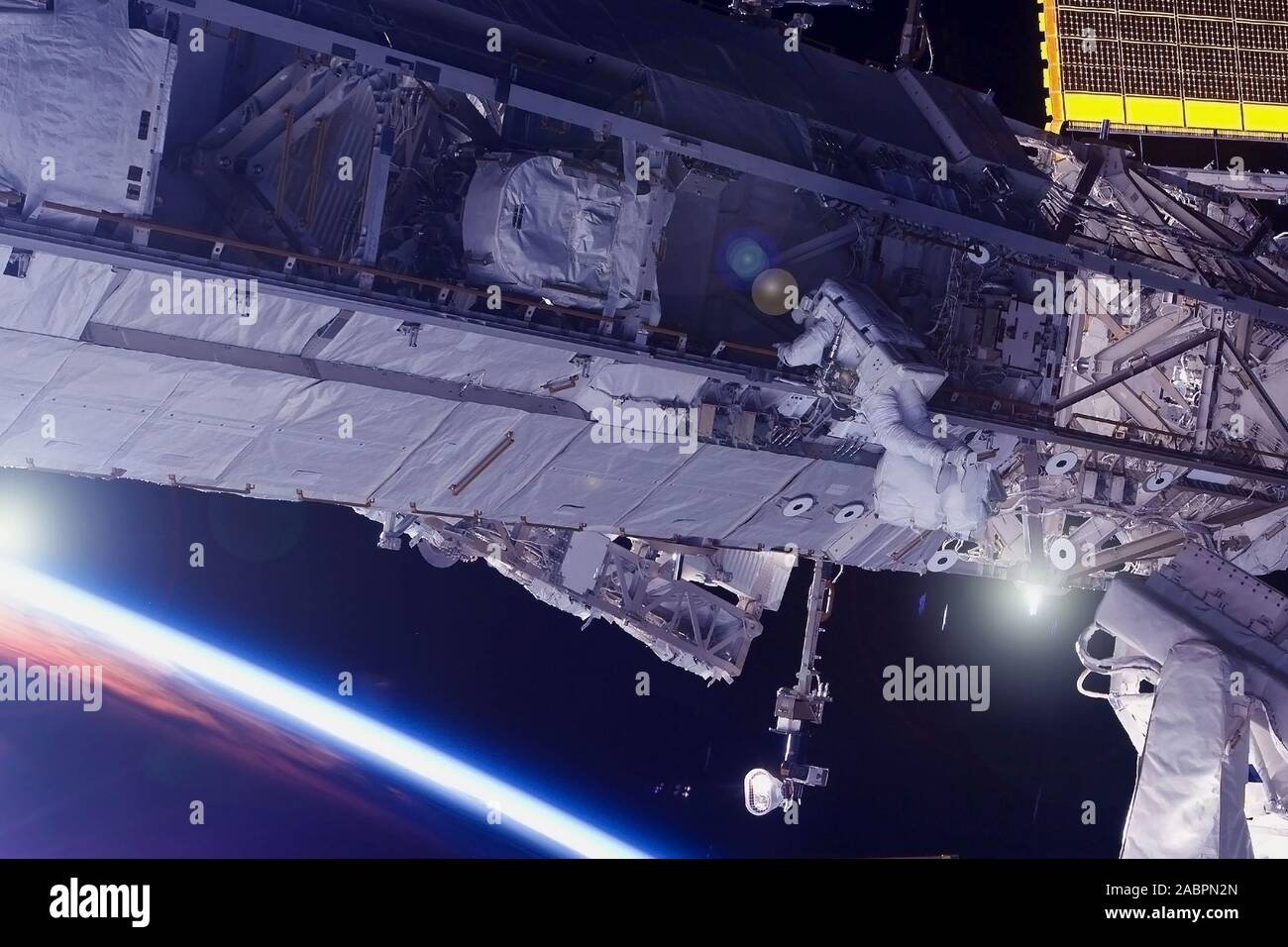 Astronaut at the space station is engaged in repairs. Elements of this ...