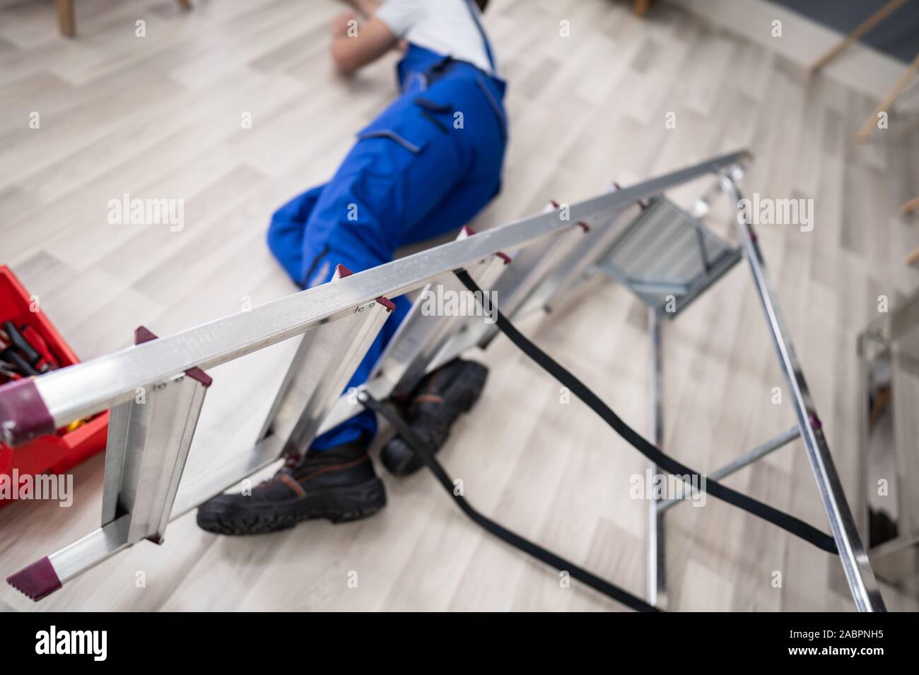 Unconscious Handyman Fallen From Ladder With Equipment Lying On Floor ...