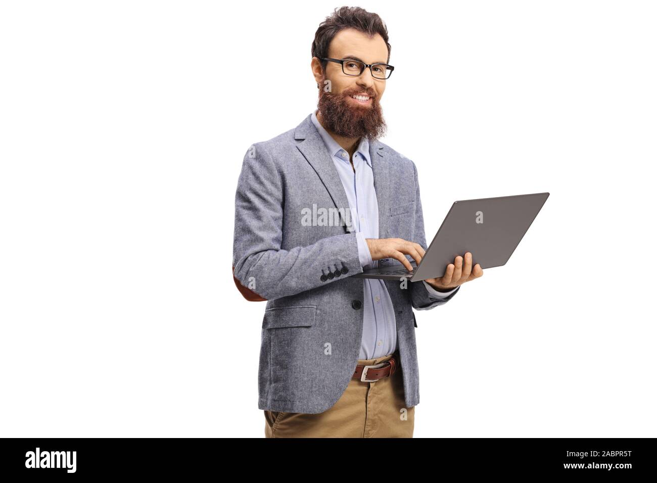 Bearded man holding a laptop computer and smiling at the camera ...