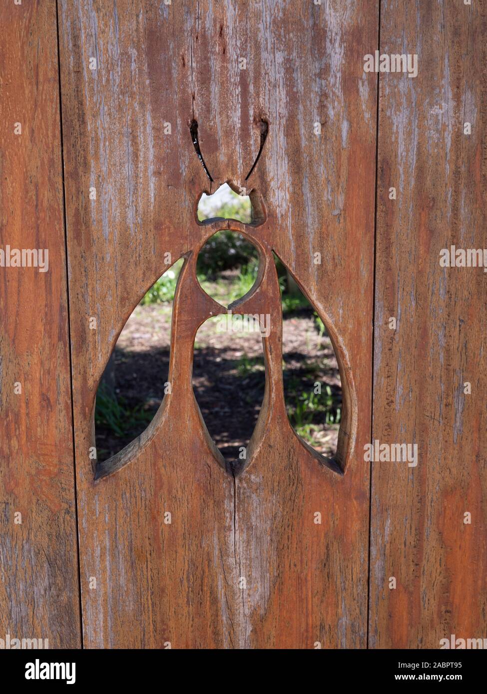 A bee shaped hole cut into a gate to an apiary in South Africa Stock ...