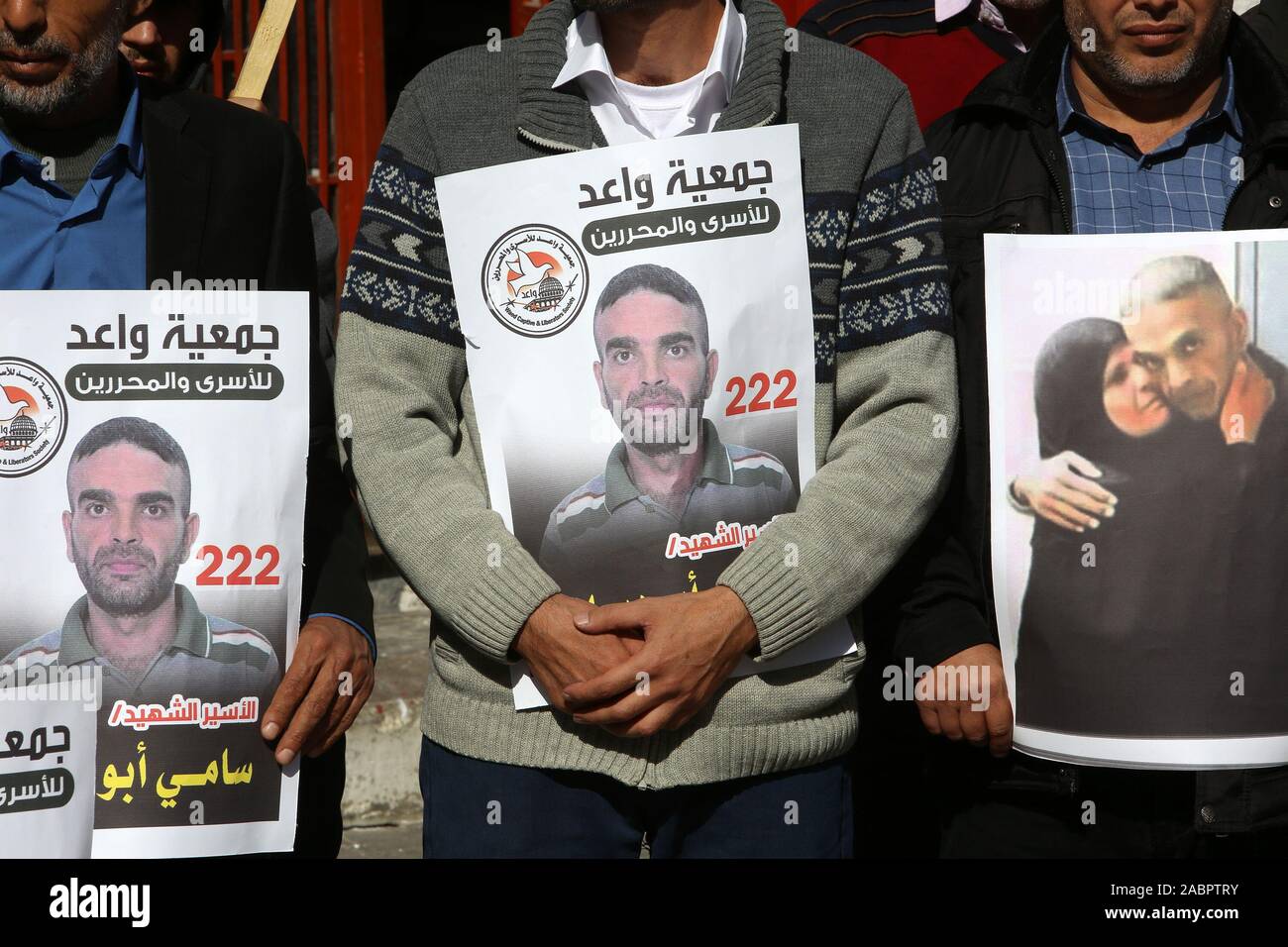 Demonstrators carry portraits of Palestinian prisoner Sami Abu Diyak in ...