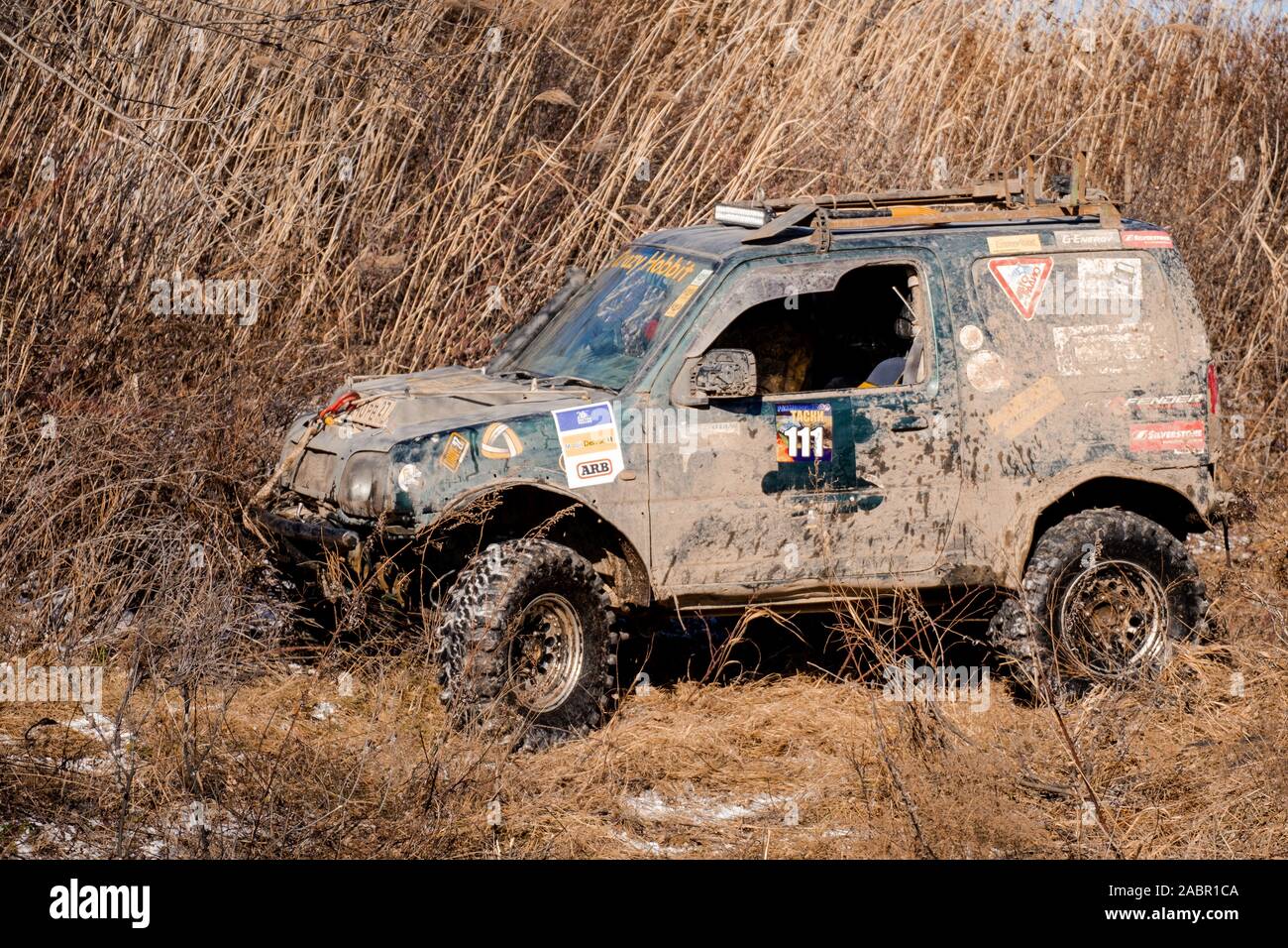 Jeep Suzuki Jimny overcomes obstacles in the forest Stock Photo - Alamy
