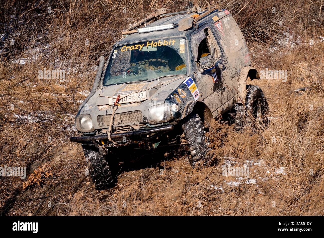 Jeep Suzuki Jimny overcomes obstacles in the forest Stock Photo - Alamy