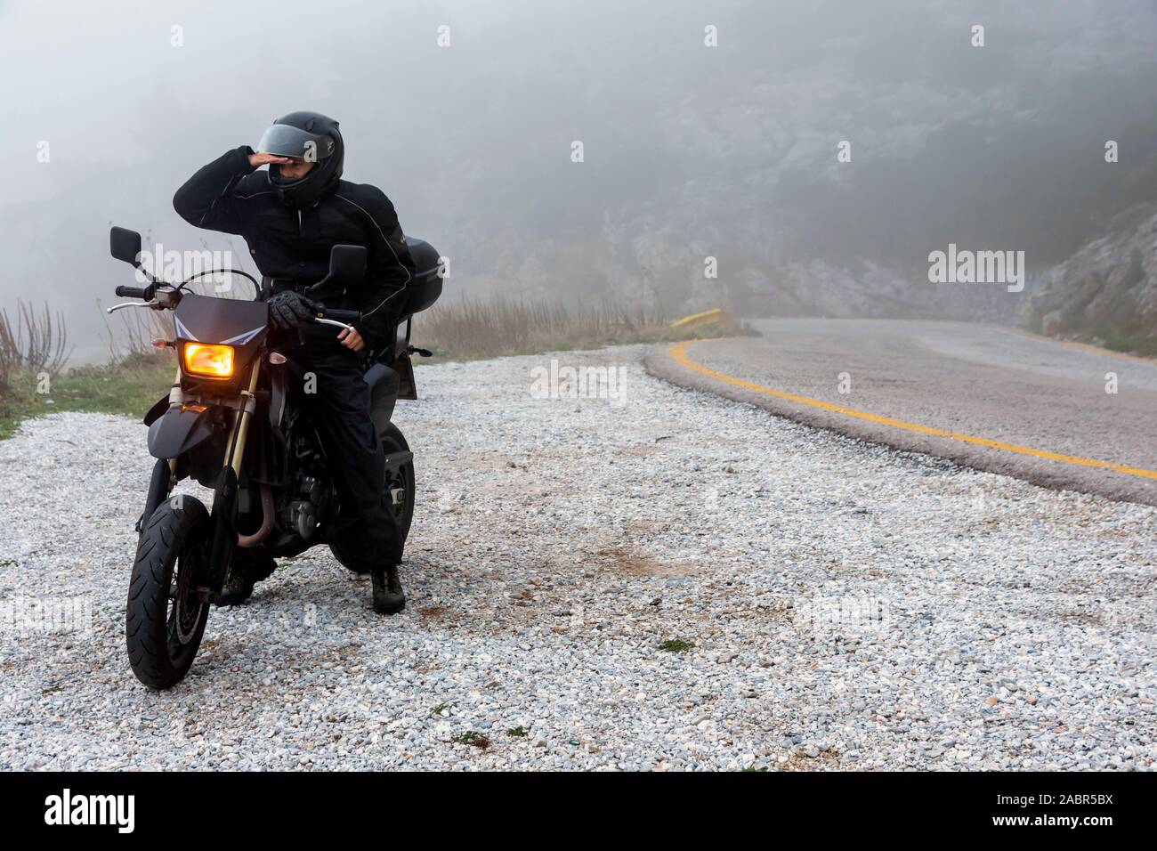 Rider trying to see through the fog on an adventure ride on the ...