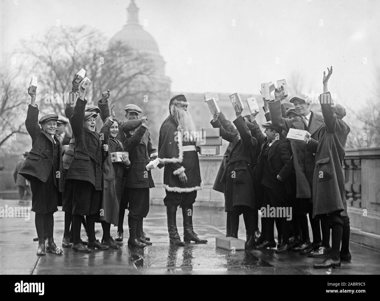 Santa with group of children; U.S. Capitol in background, Washington, D ...