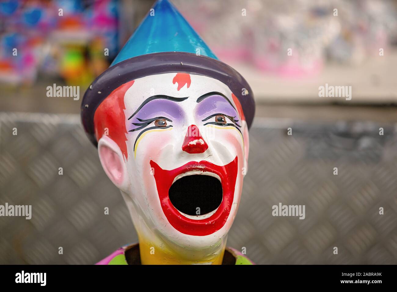 A painted clown figurine with open mouth ready for child to put in a ...