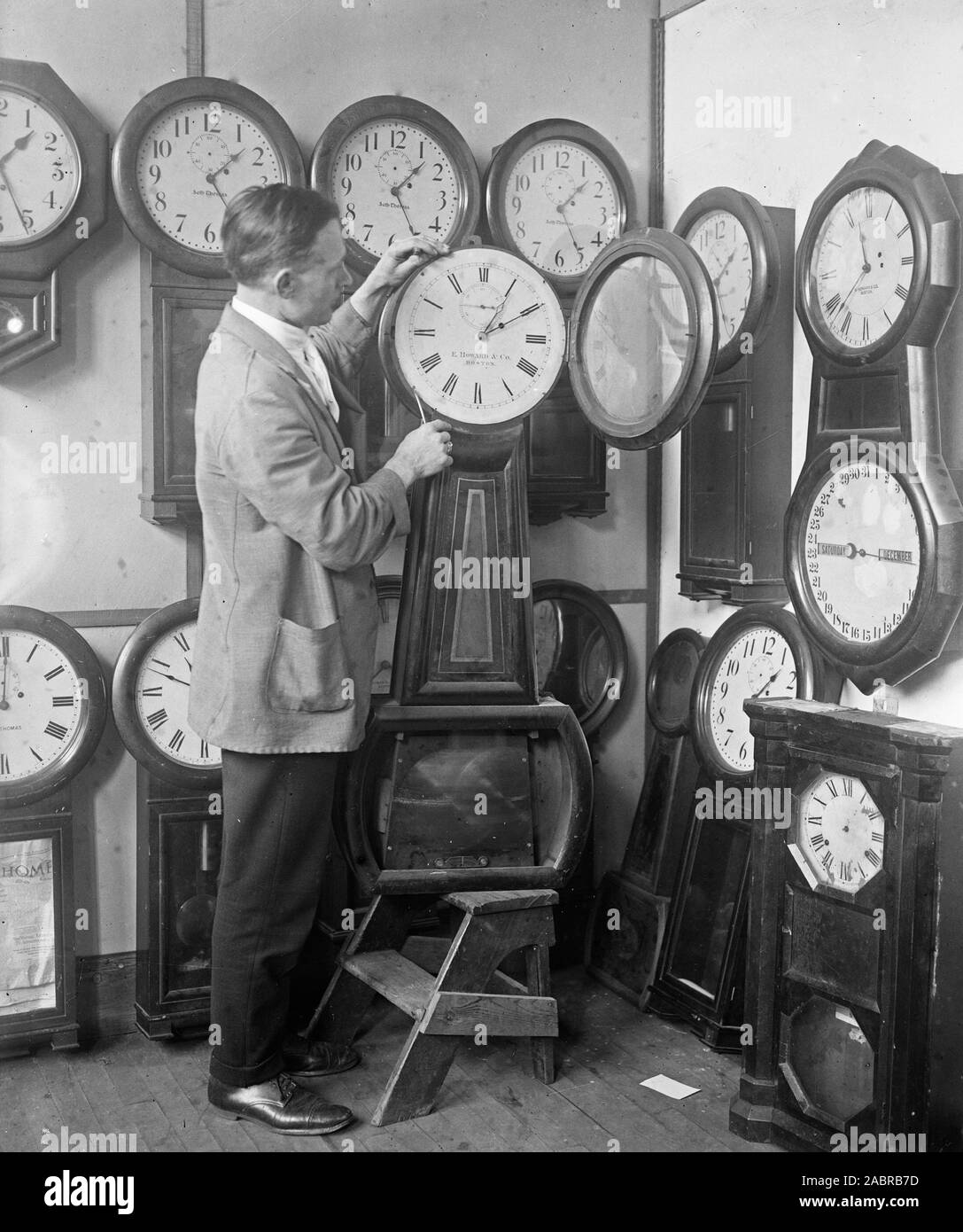A man working on one of his many clocks ca. 1924 Stock Photo - Alamy