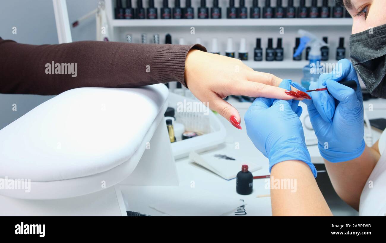 Manicurist drawing on nail close hi-res stock photography and images ...