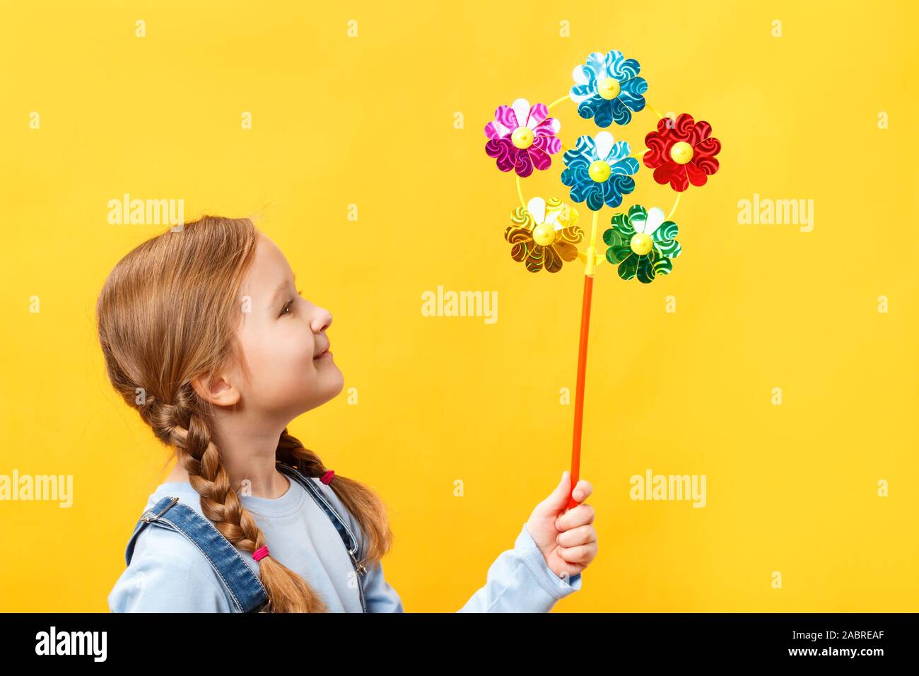 Girl with a pinwheel hi-res stock photography and images - Alamy